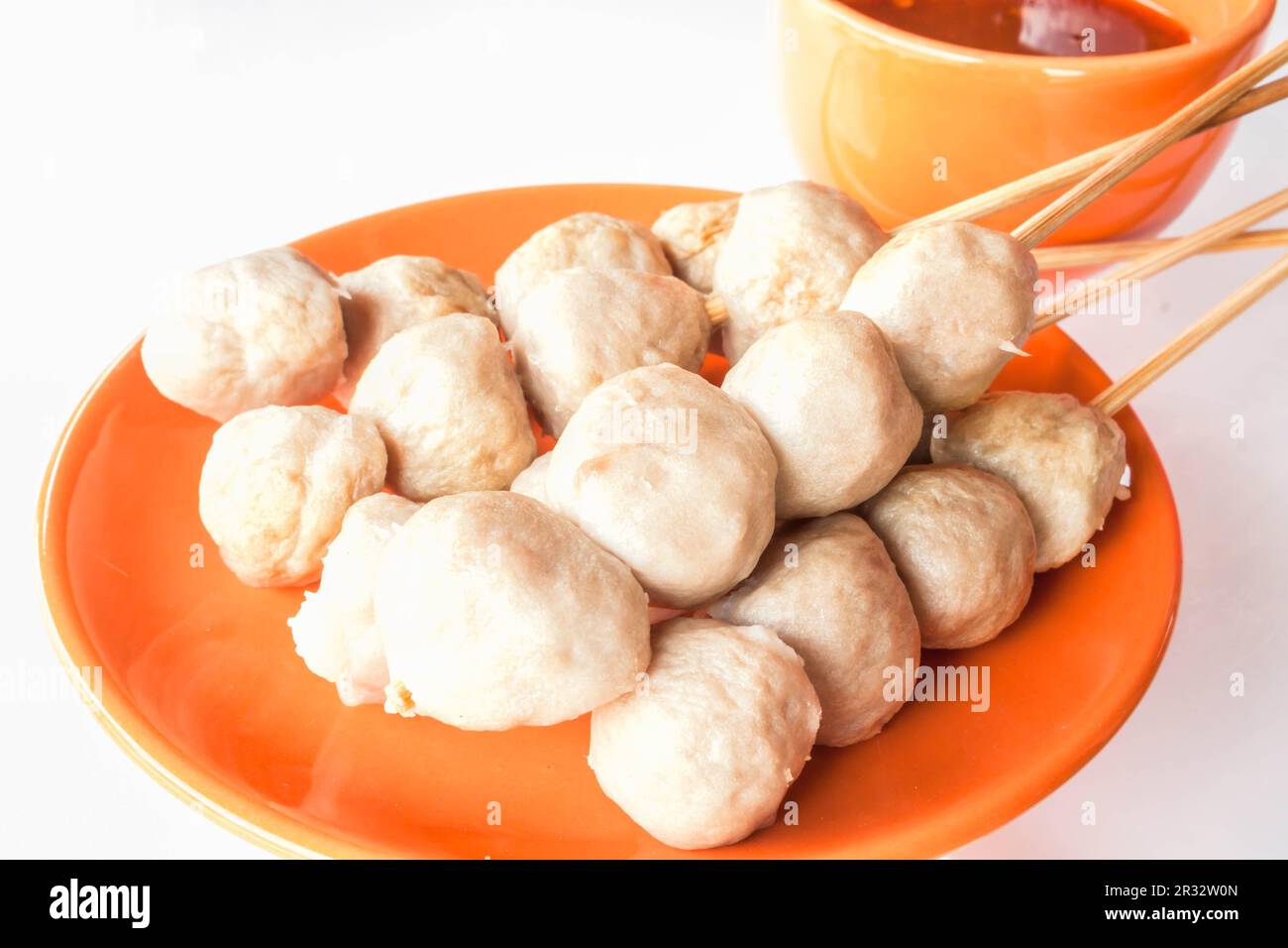 Mini pork balls in orange dish on clean table Stock Photo - Alamy