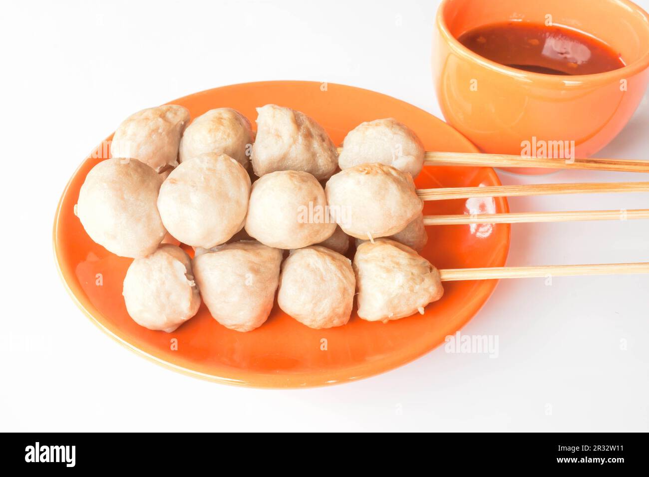 Mini pork balls in orange dish on clean table Stock Photo - Alamy