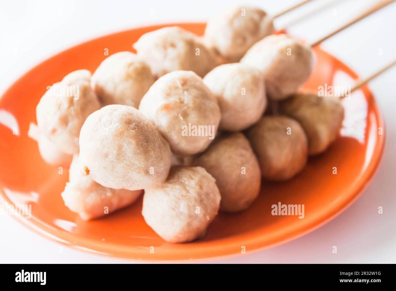 Mini pork balls in orange dish on clean table Stock Photo - Alamy