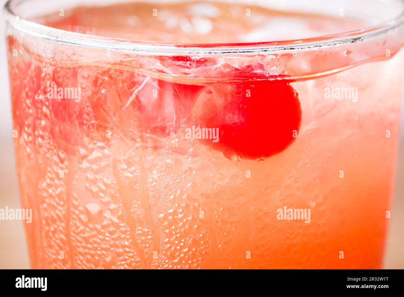 Red cherry on iced mix fruits juice soda Stock Photo - Alamy