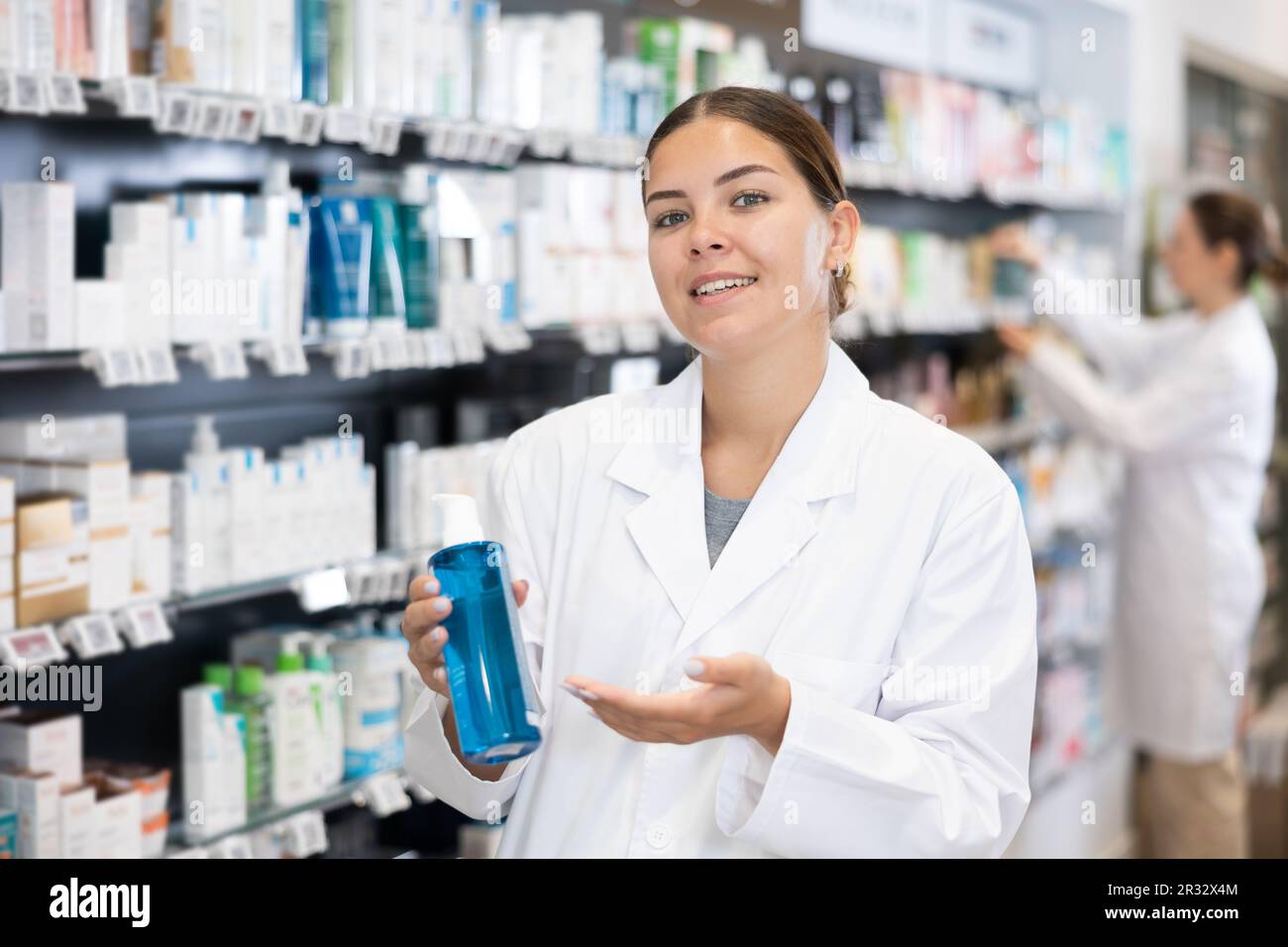 Female pharmacist offers cosmetics products while standing in the ...
