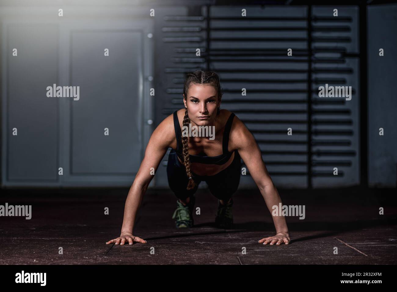 Young strong sweaty focused athlete muscular woman with muscles heavy ...