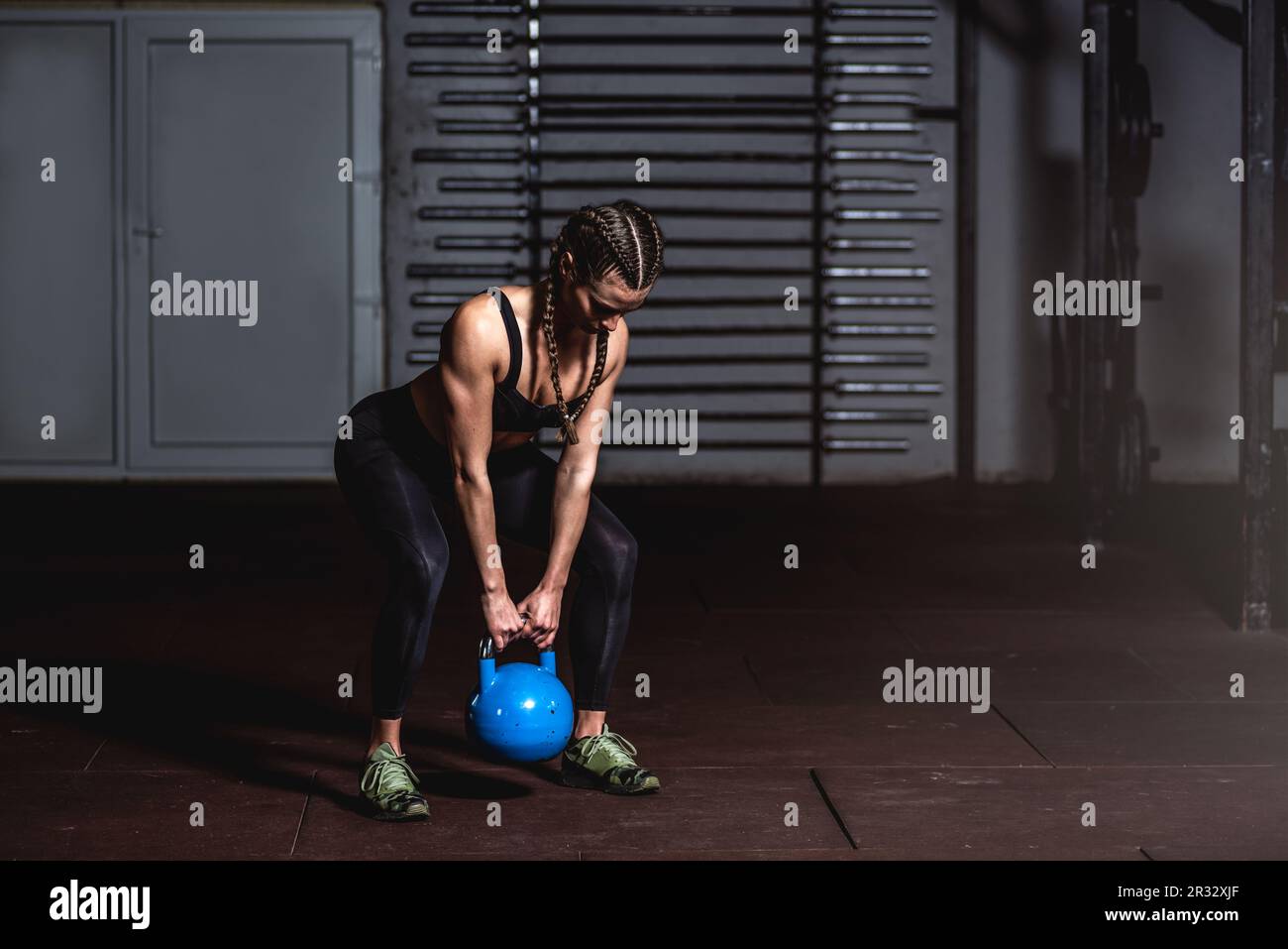 Young strong sweaty focused athlete muscular woman with muscles heavy ...