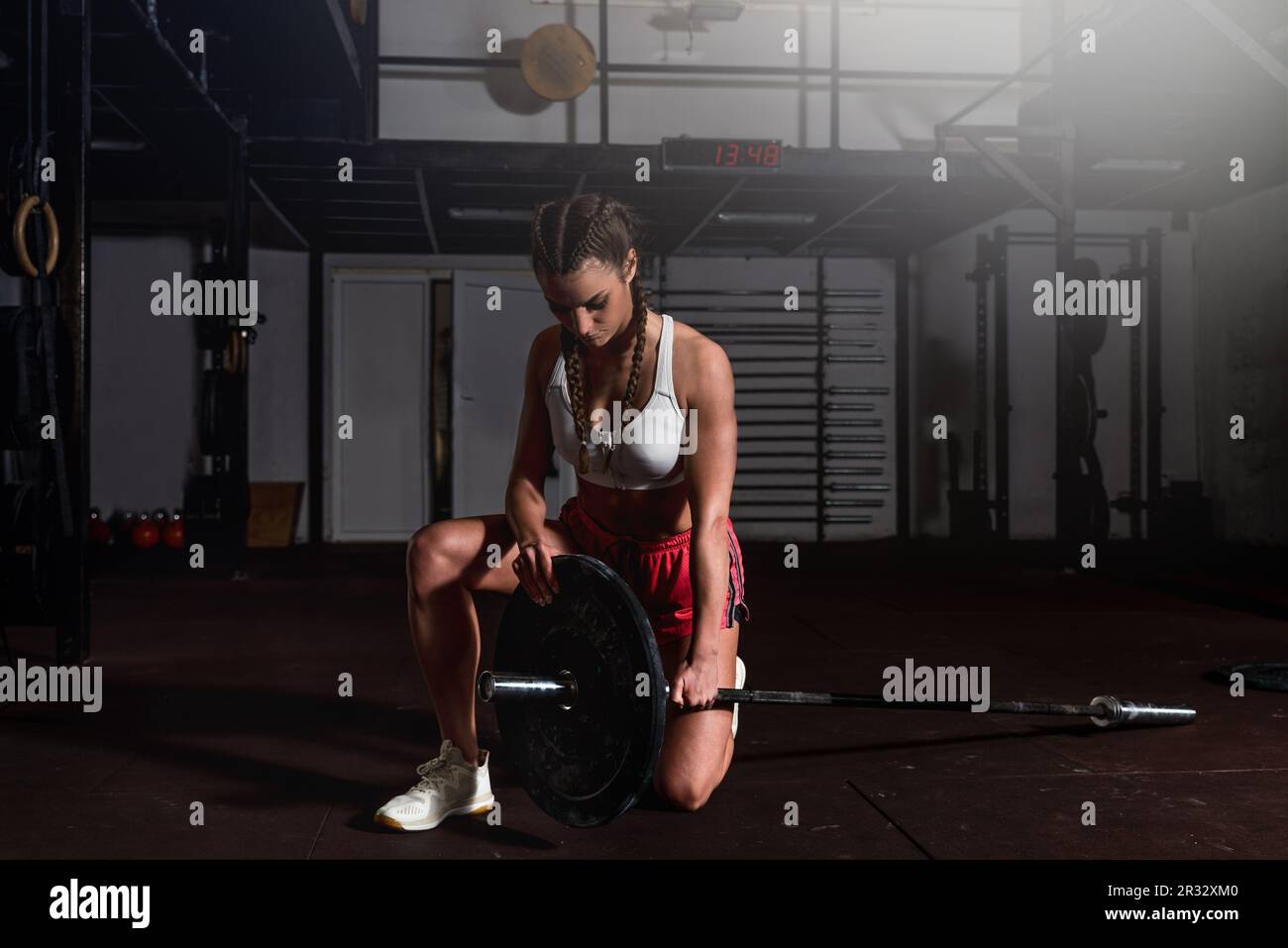 Young strong sweaty focused athlete muscular woman with muscles heavy ...