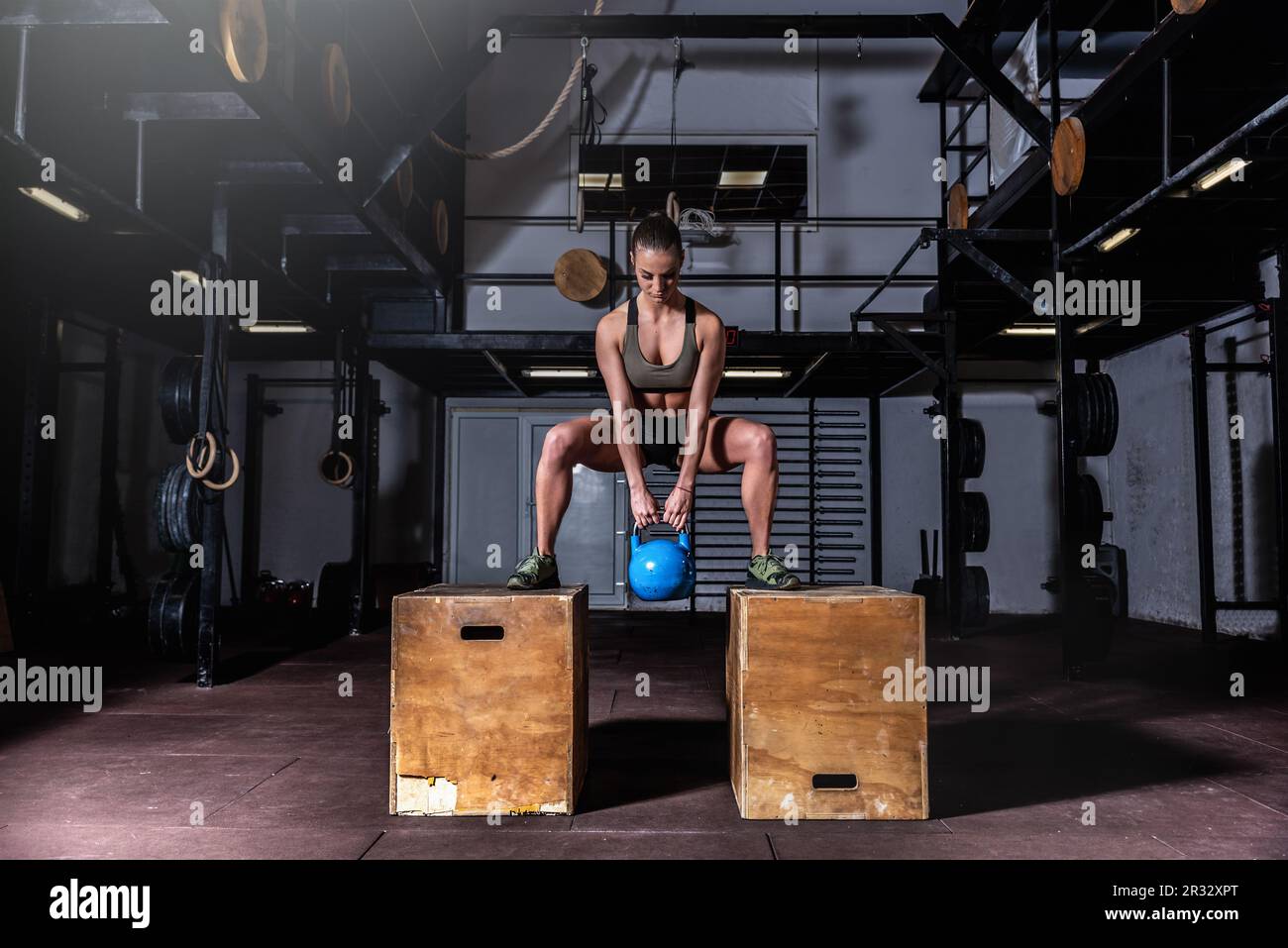 Young strong sweaty focused athlete muscular woman with muscles heavy ...