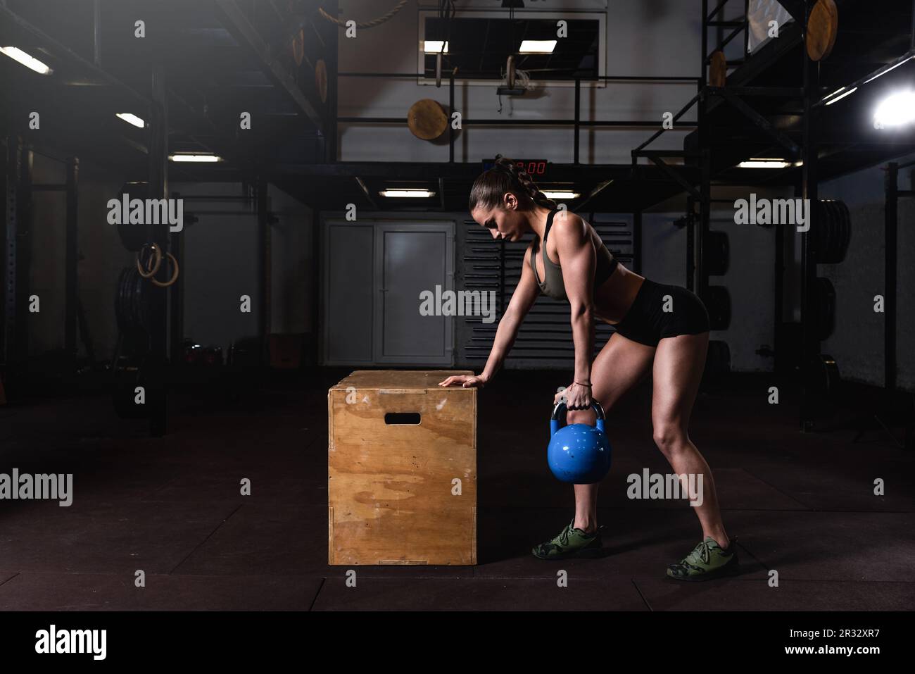 Young strong sweaty focused athlete muscular woman with muscles heavy ...
