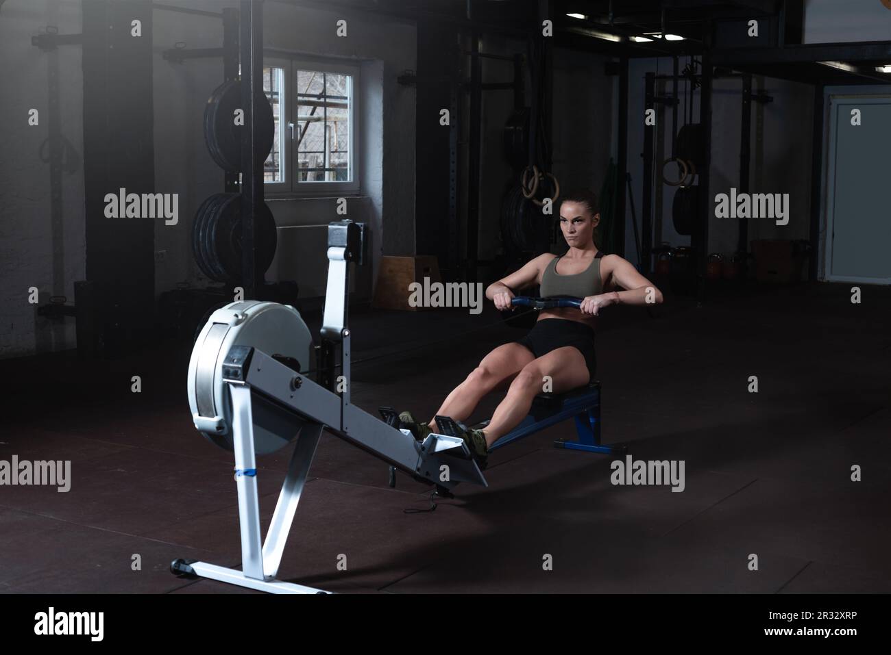 Young strong sweaty focused athlete muscular woman with muscles heavy ...