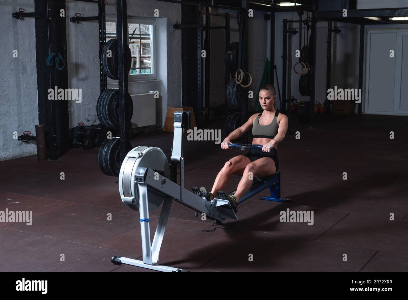 Young strong sweaty focused athlete muscular woman with muscles heavy ...