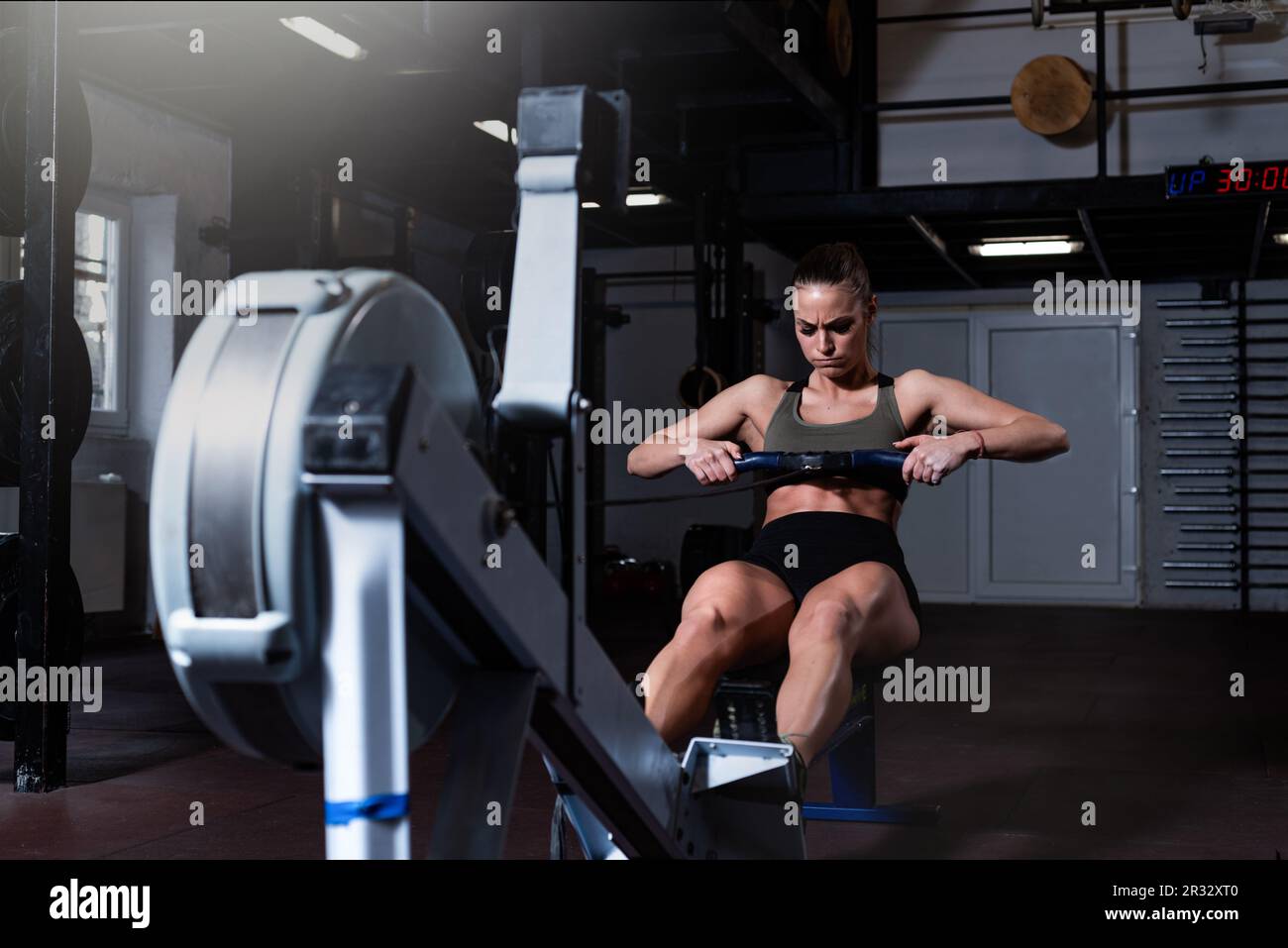 Young strong sweaty focused athlete muscular woman with muscles heavy ...
