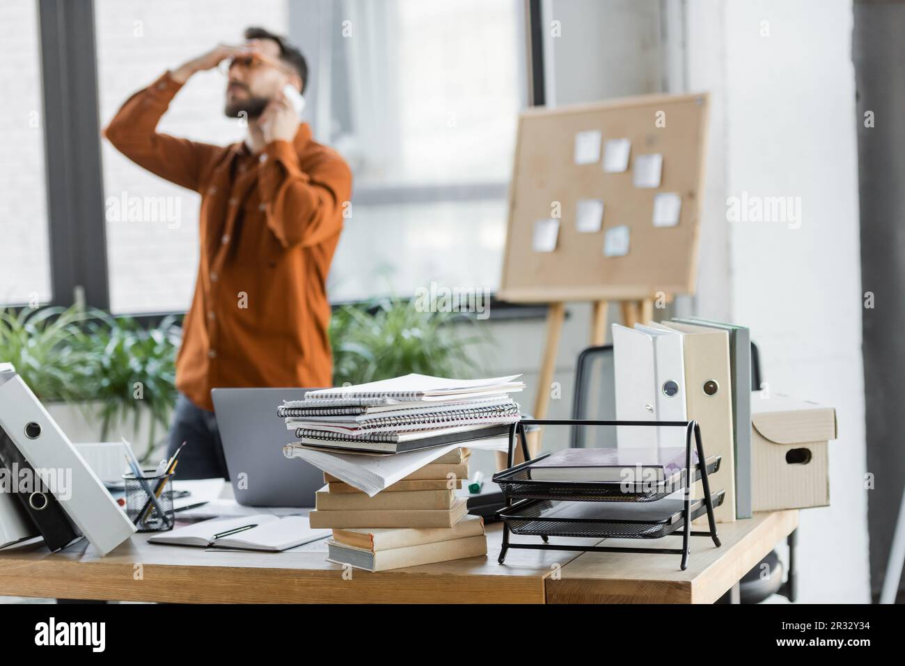 busy and tired businessman talking on smartphone while solving problem ...