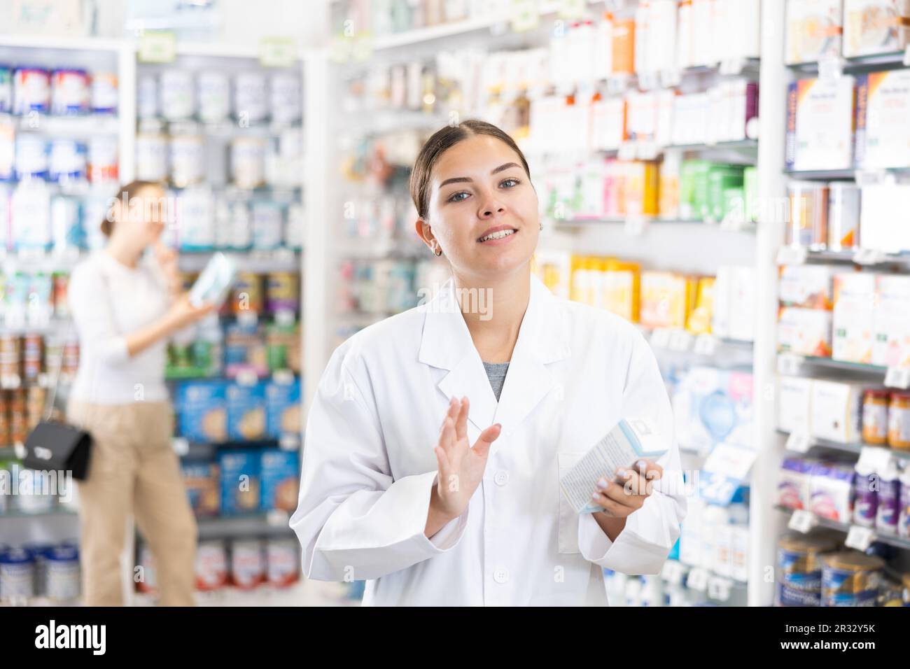 In pharmacy, apothecary holds package with cream for sensitive skin and ...