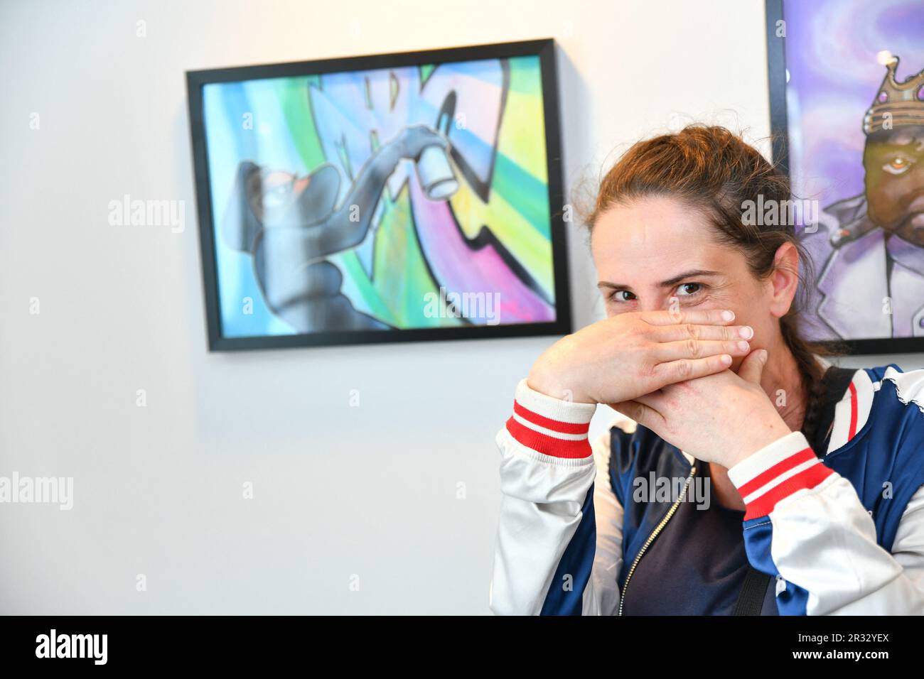 Artist MadC staning beside of the drawing representing her at the ...