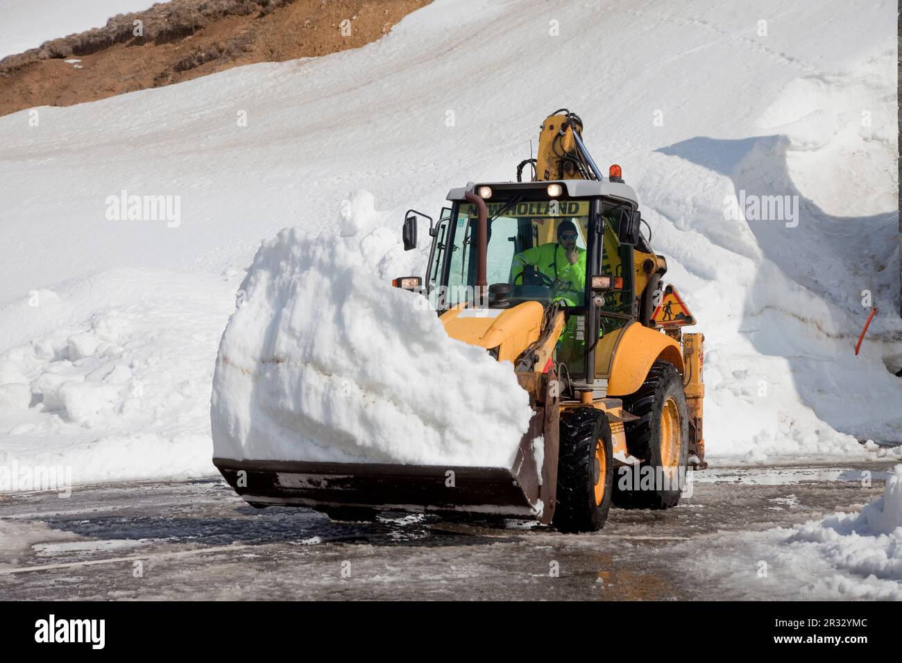 Col Du Galibier, France. 22nd May, 2023. A backhoe plows the road ...