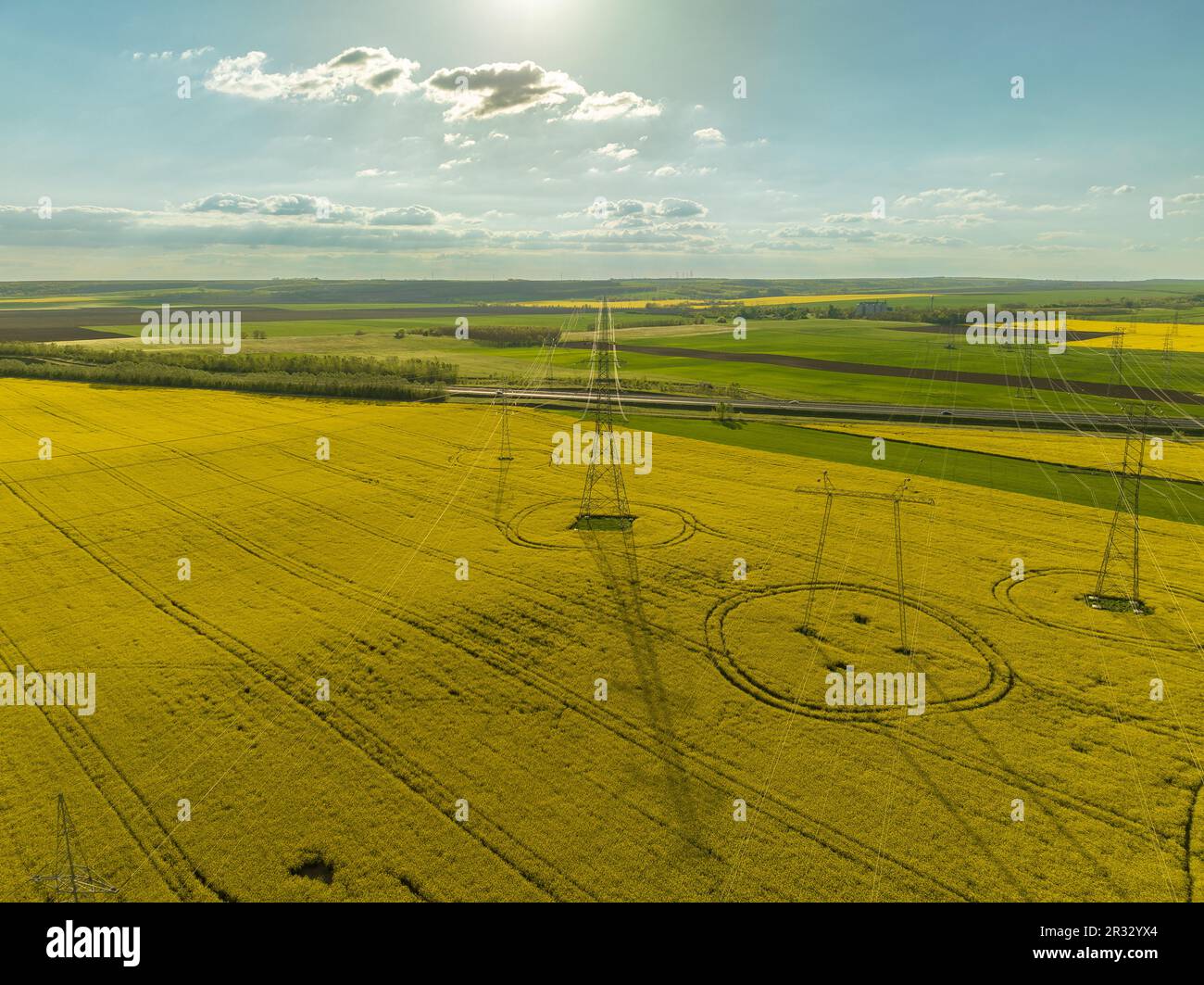 high voltage electrical transmission tower in an agriculture field ...