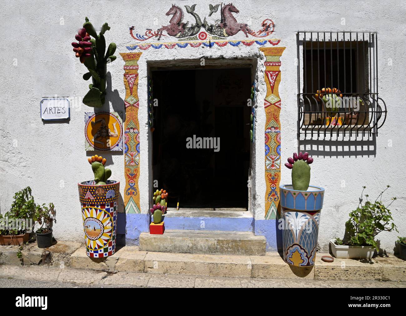 Local art shop facade with a whitewashed wall, hand painted trim ...
