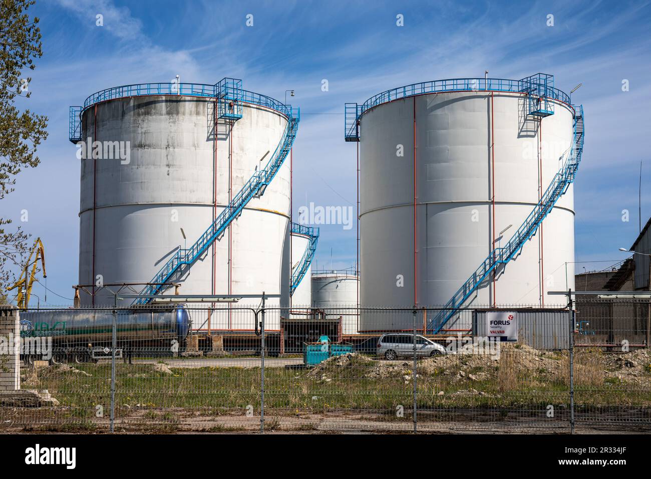 Large industrial bulk storage tanks against blue sky in Karjamaa ...