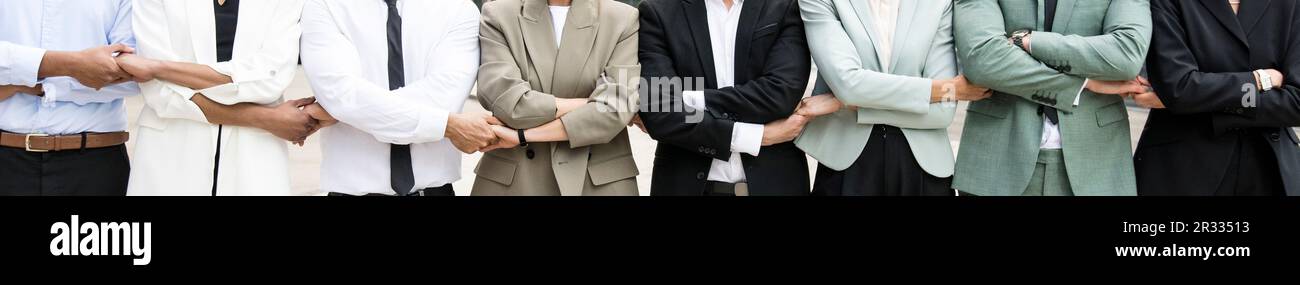 Panoramic close up of an executive team standing in a line holding ...