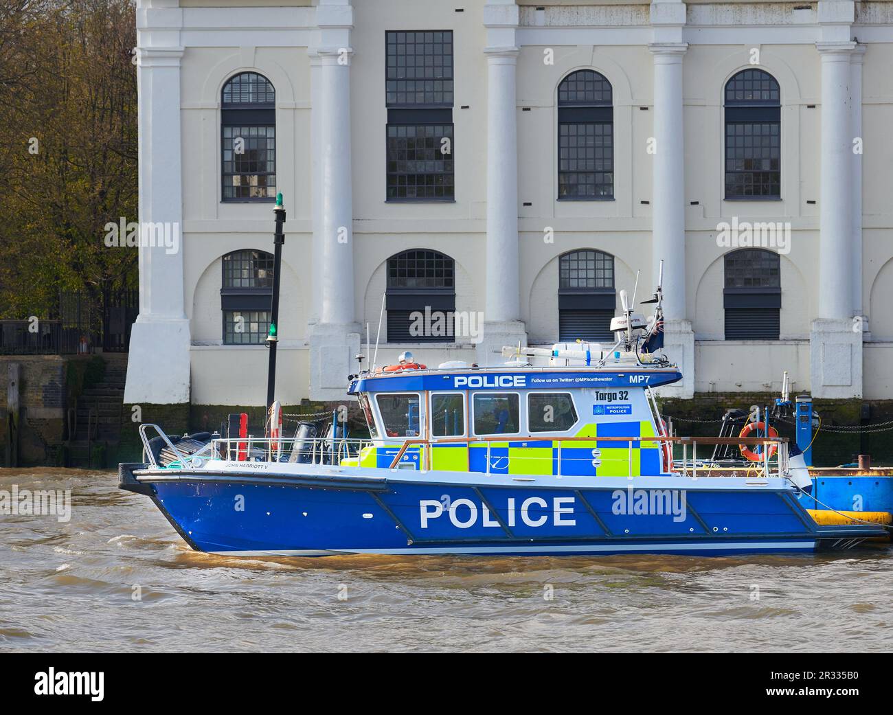 A Metropolitan police boat moored at its base on the river Thames next ...
