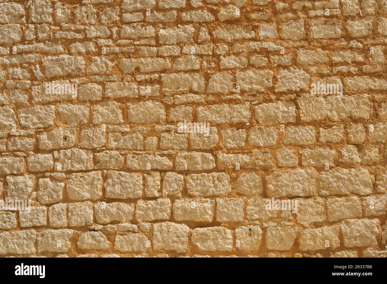 horizontal texture of an old wall made of rubble stone, brown sandstone ...