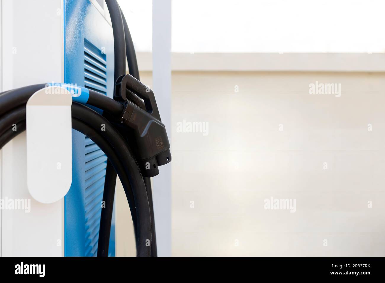 electric car charging station at outdoor parking place with soft-focus ...