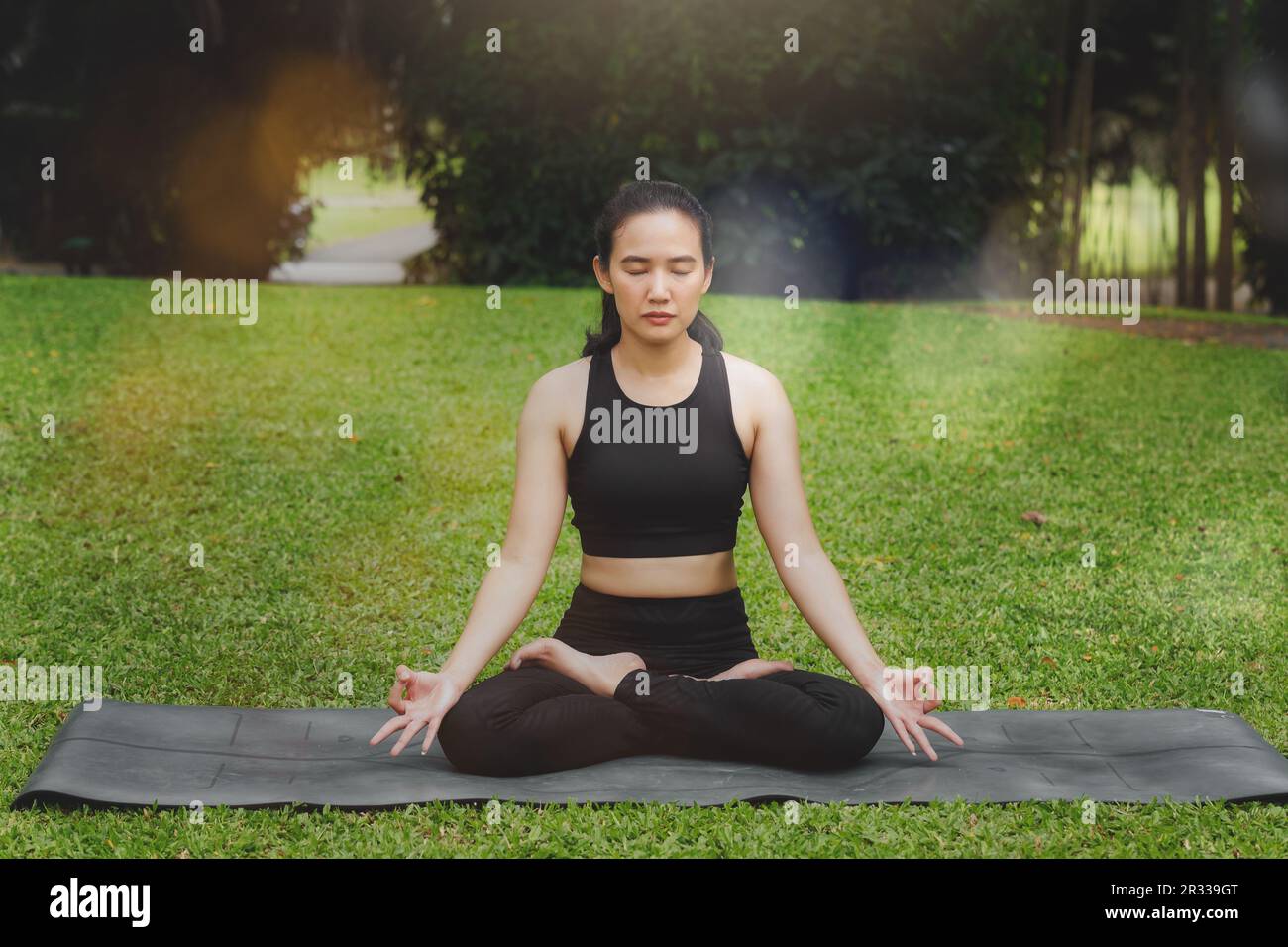 Asian woman practicing yoga in Root Bond, Mula Bandha pose on the mat ...
