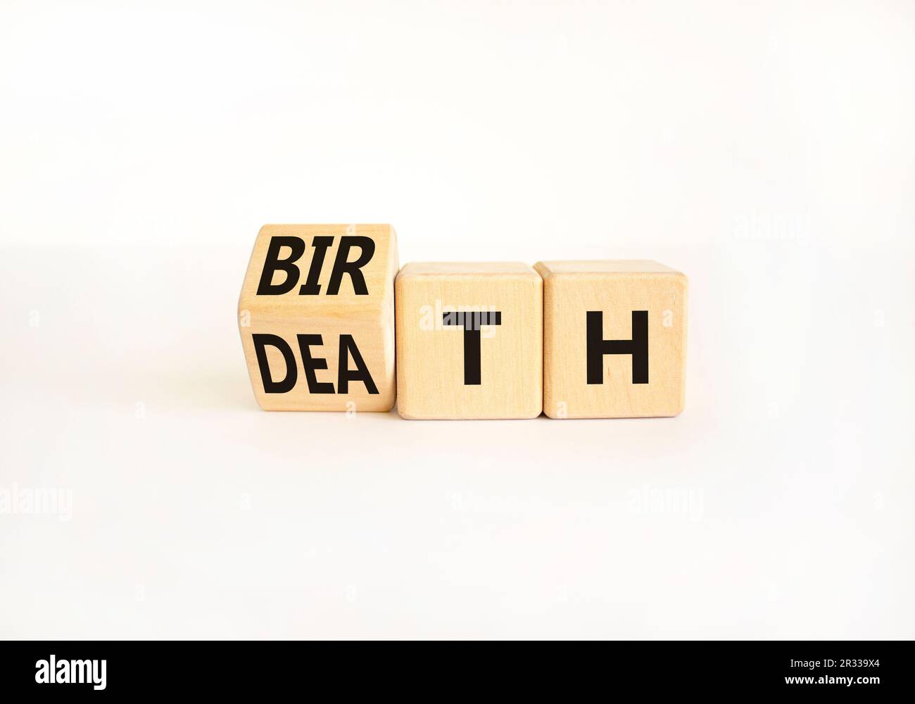 Birth or death symbol. Businessman turns wooden cubes and changes the ...