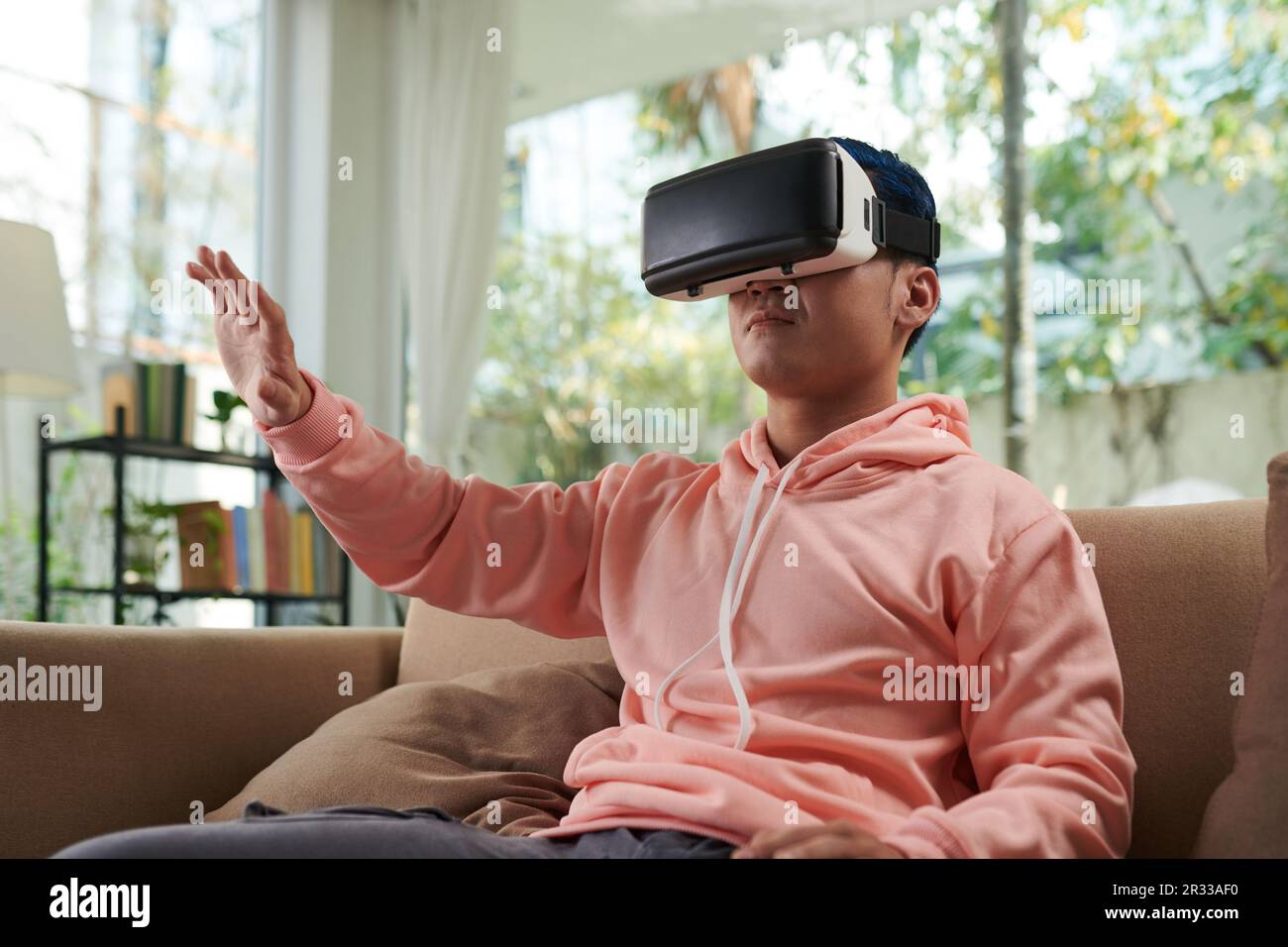 Zoomer in virtual reality glasses exploring metaverse Stock Photo - Alamy Zoomer in virtual reality glasses exploring metaverse Stock Photo - Alamy