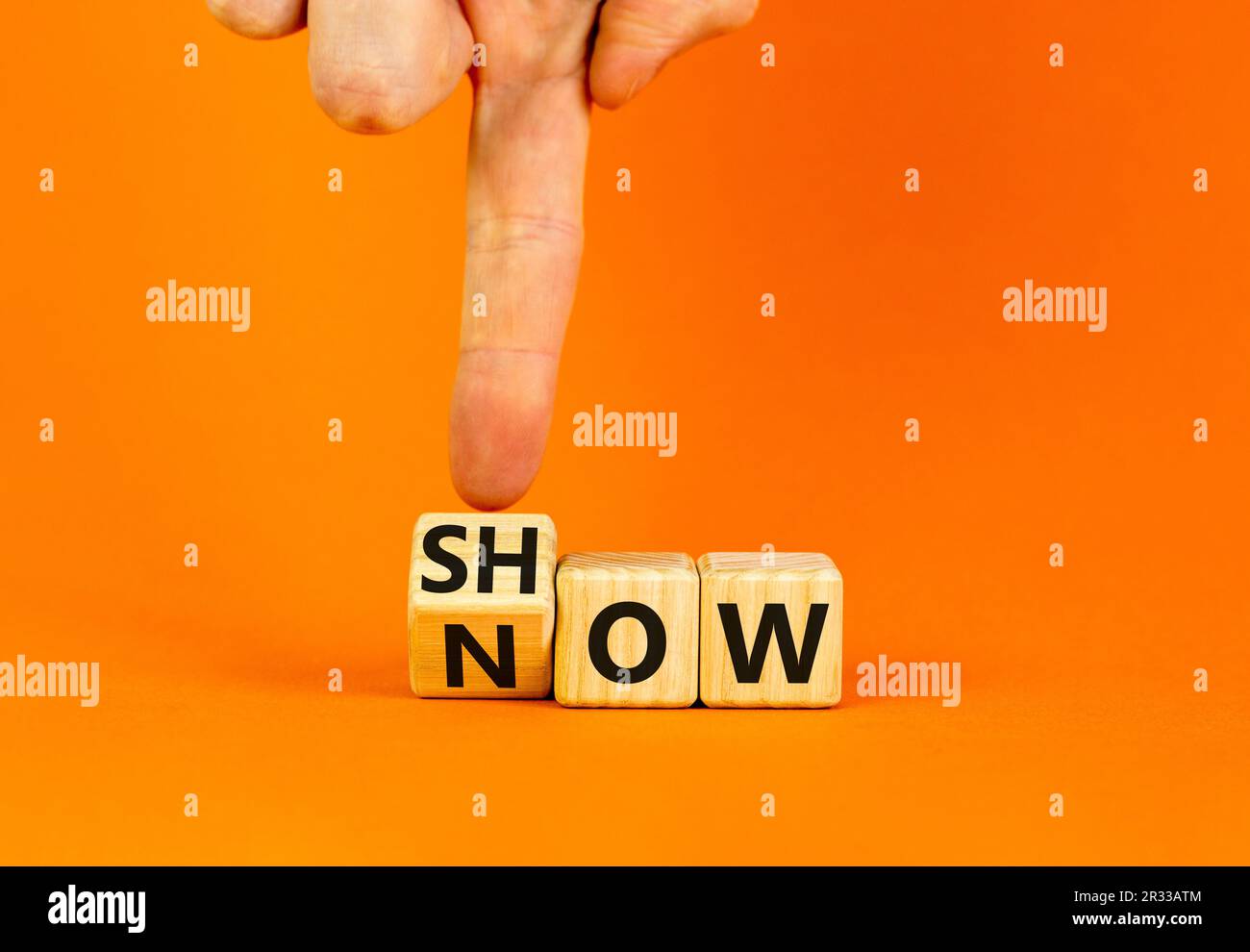 Show now symbol. Businessman turns wooden cubes and changes the word ...
