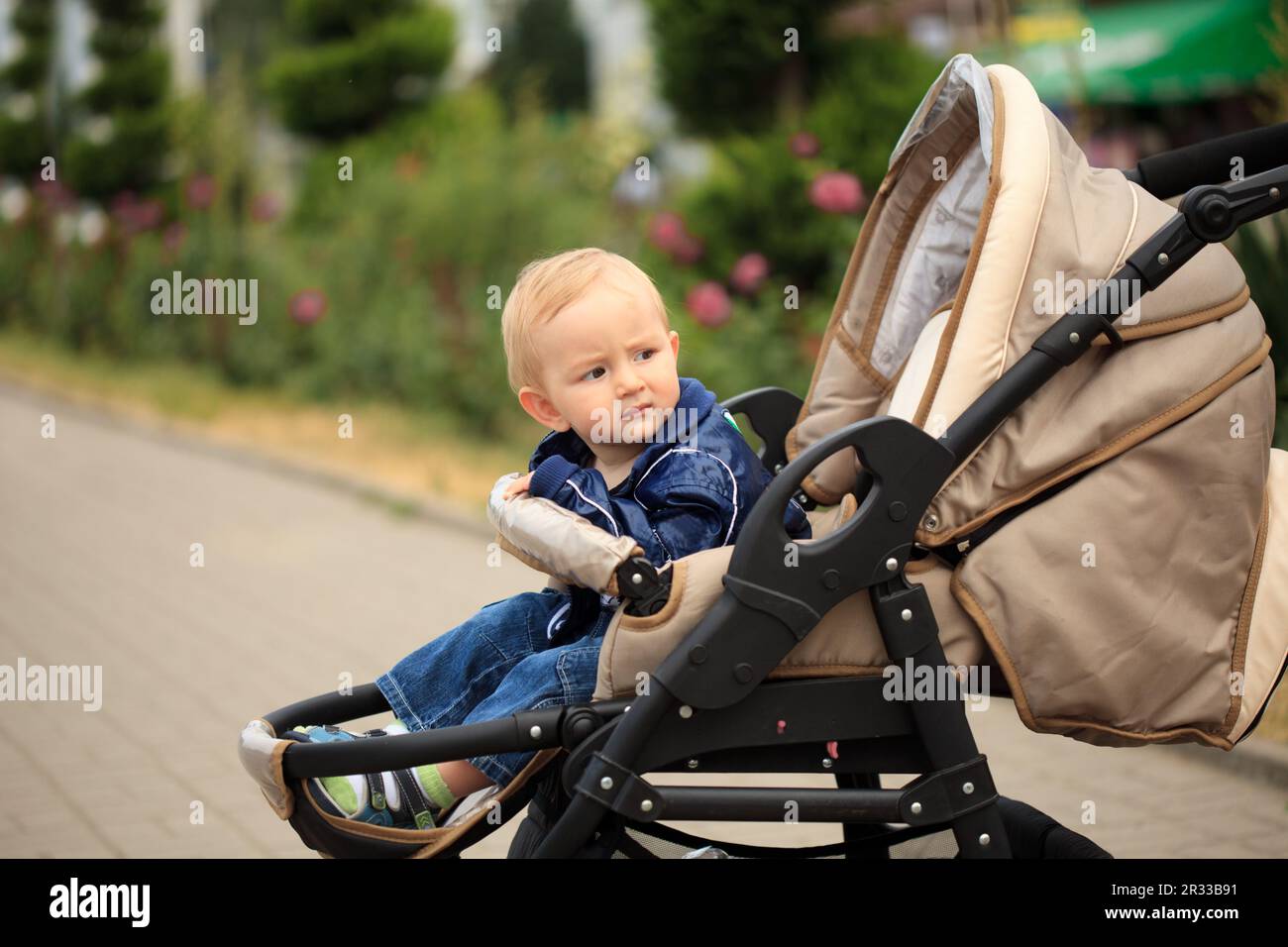 Toddler in baby carriage Stock Photo - Alamy