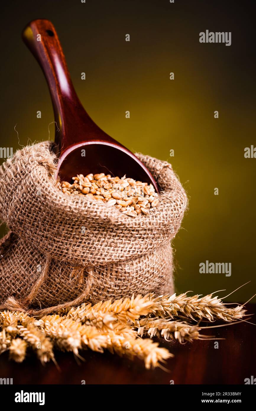 Wheat in burlap sack Stock Photo - Alamy