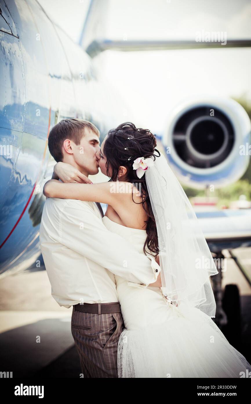Wedding couple fly on honeymoon Stock Photo - Alamy