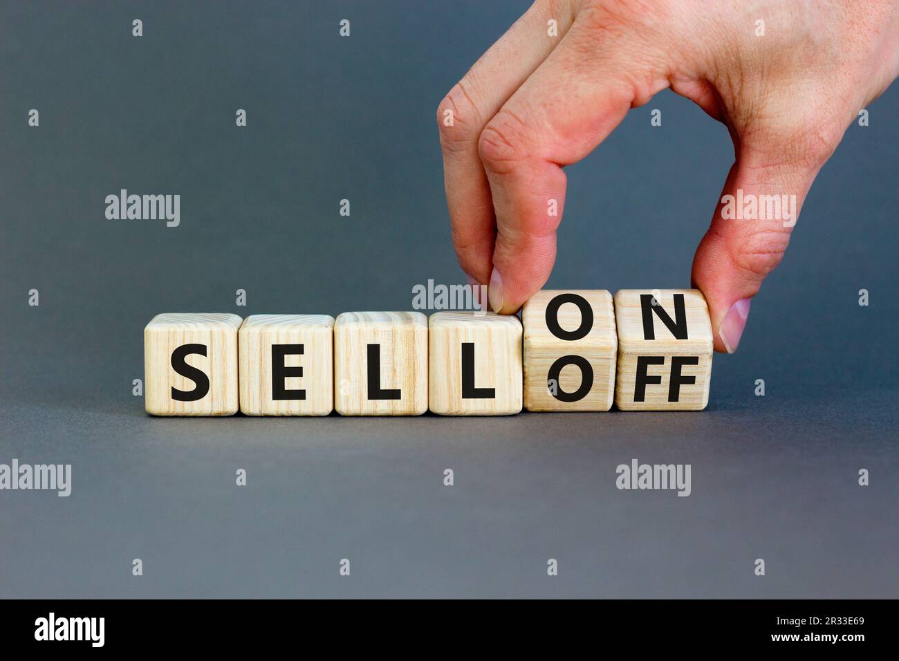 Sell on or off symbol. Businessman turns wooden cubes and changes word ...