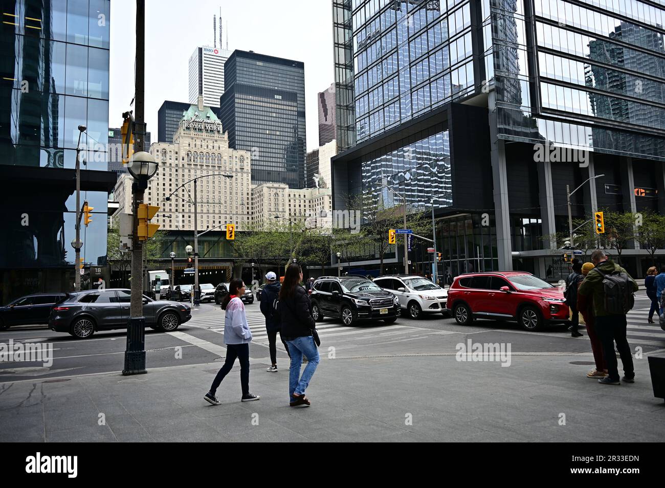 People walk on the street in Toronto, Canada; with the Fairmont Royal ...