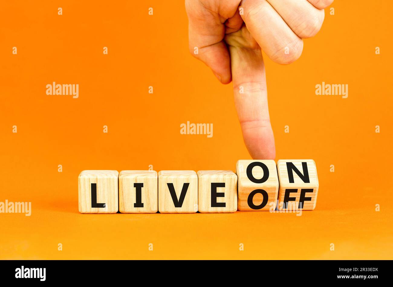 Live on or off symbol. Businessman turns wooden cubes and changes word ...