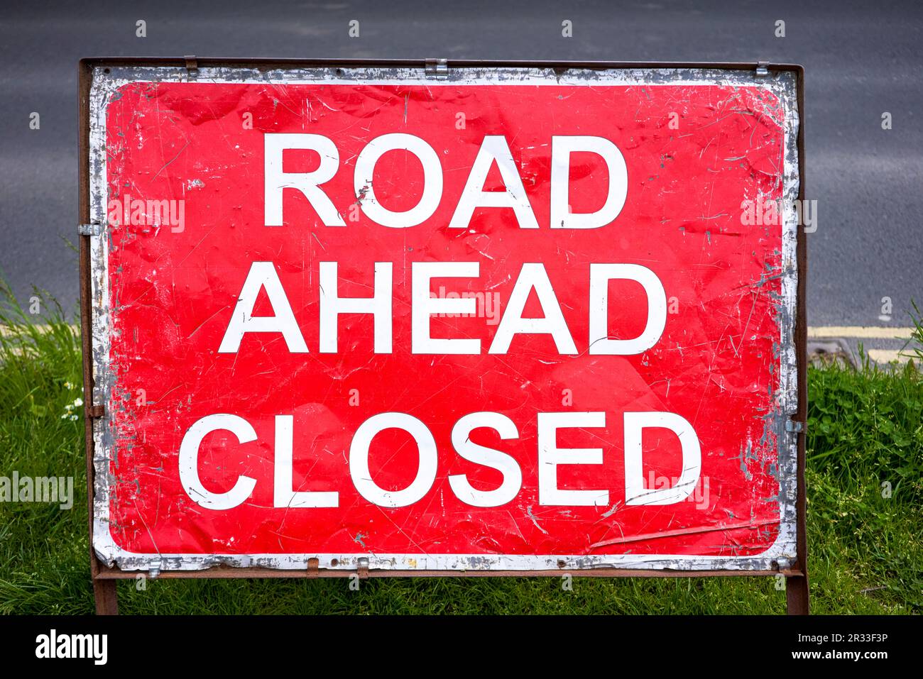 Scratched and dented red road ahead closed traffic sign Stock Photo - Alamy