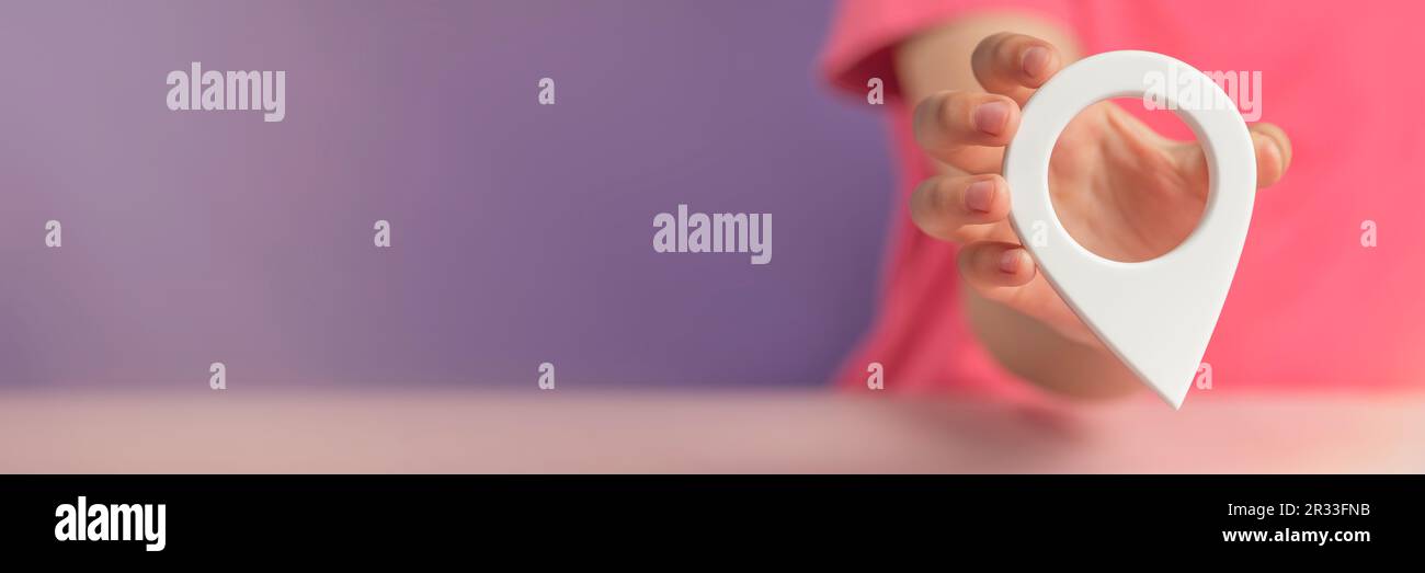 A hand holds a location sign on a purple background. Laying a route ...