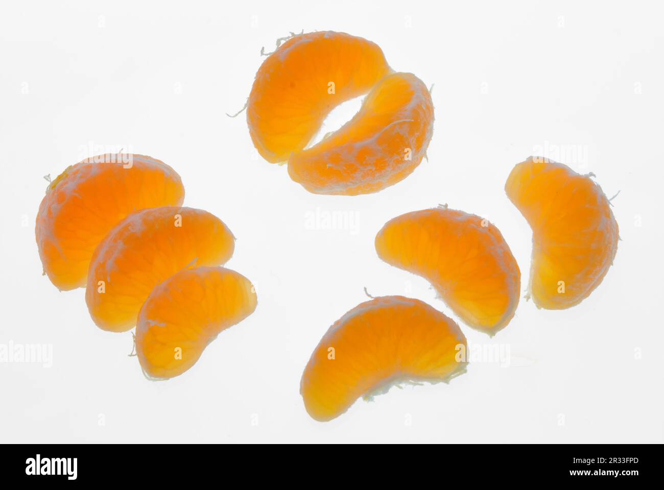 Groups of segments of a tangerine Stock Photo - Alamy