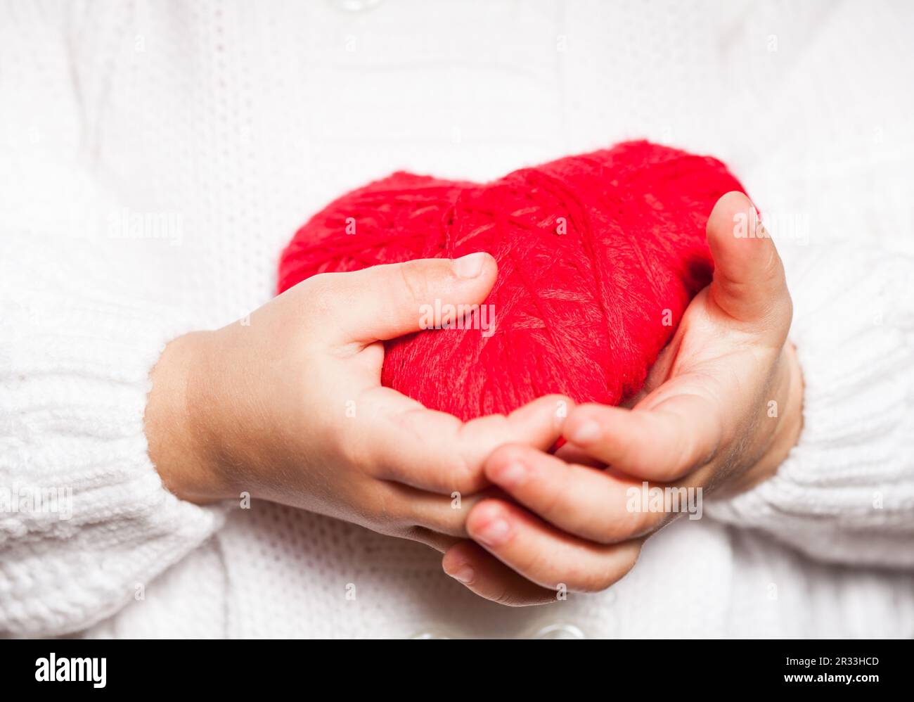Red heart in hands Stock Photo - Alamy
