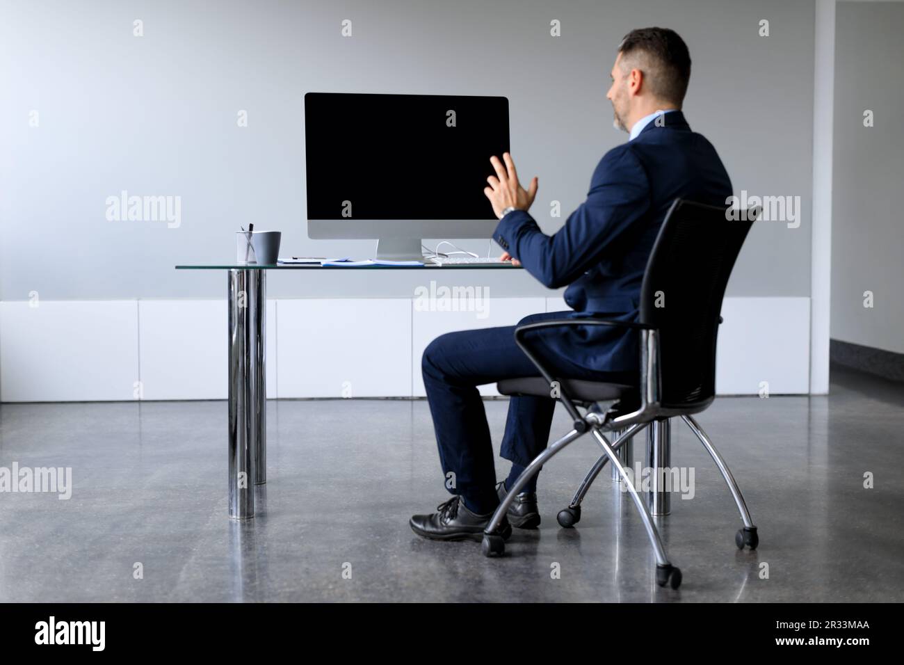 Businessman in suit looking at pc computer with blank hi-res stock ...