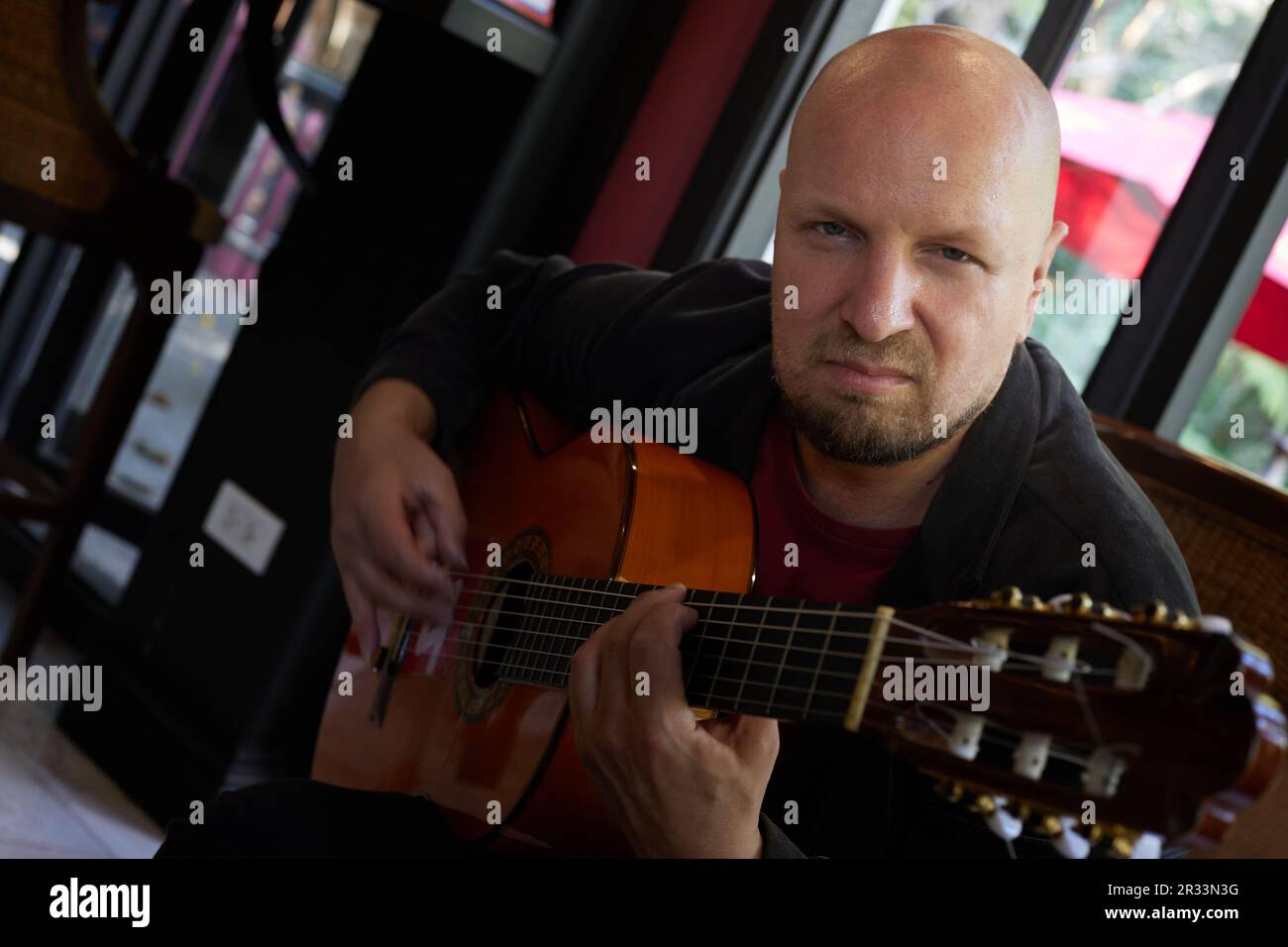 Indoor music event features a male musician passionately playing ...