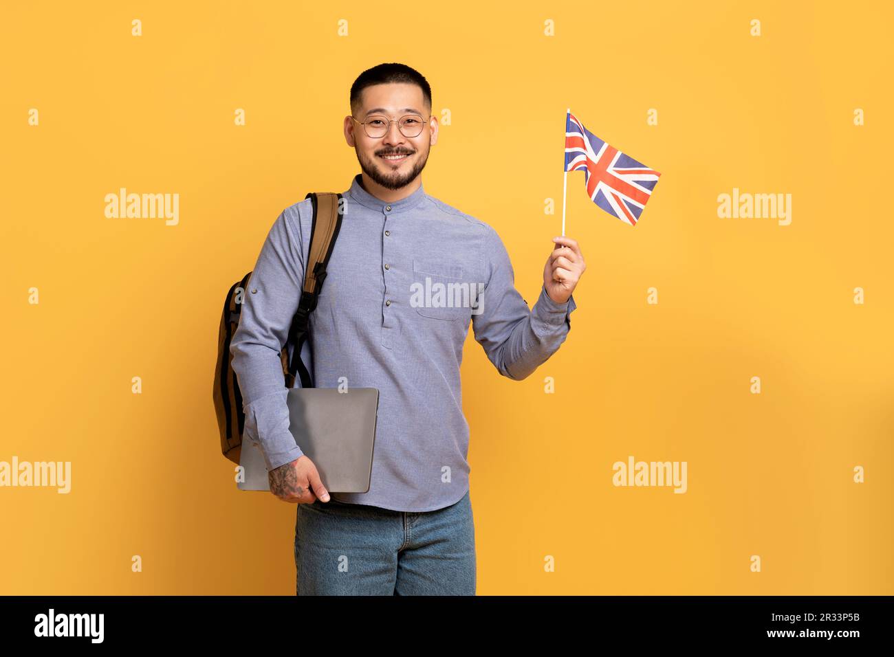 Education Abroad. Smiling Young Asian Man Posing With Laptop And ...