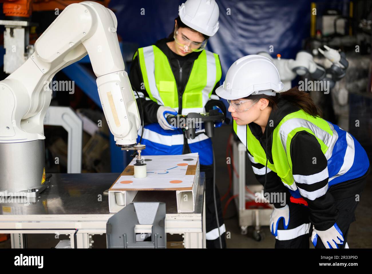 Couple of happy female maintenance engineers working at factory Stock Photo - Alamy