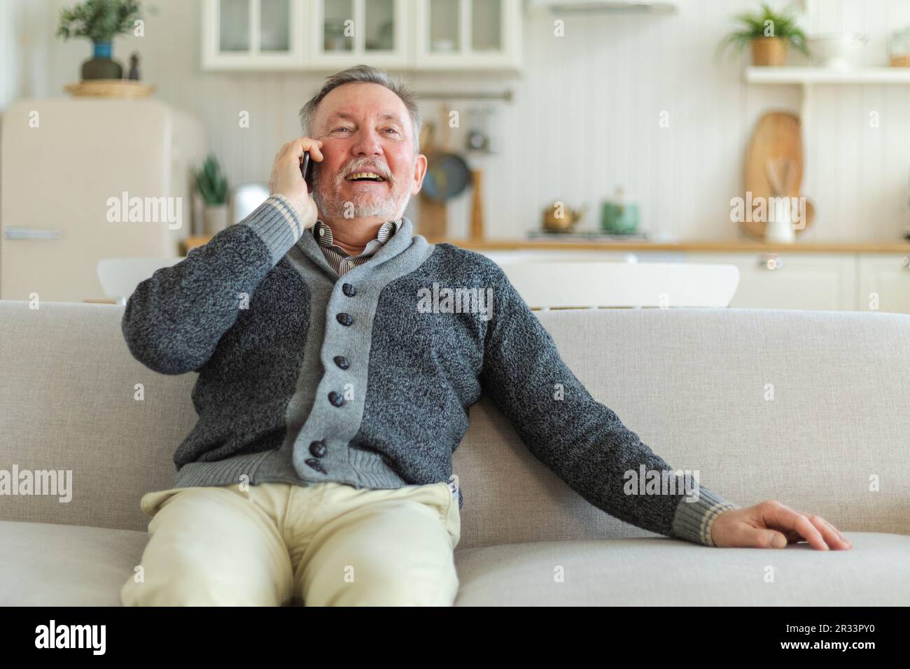 Happy middle aged senior man talking on smartphone with family friends ...
