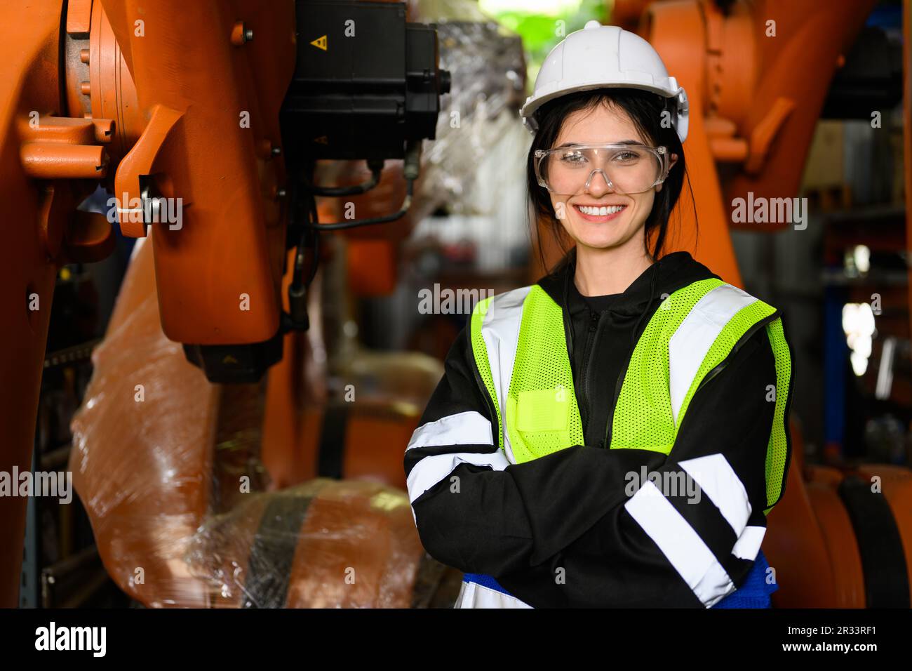 Happy female maintenance engineer worker working at industrial factory ...