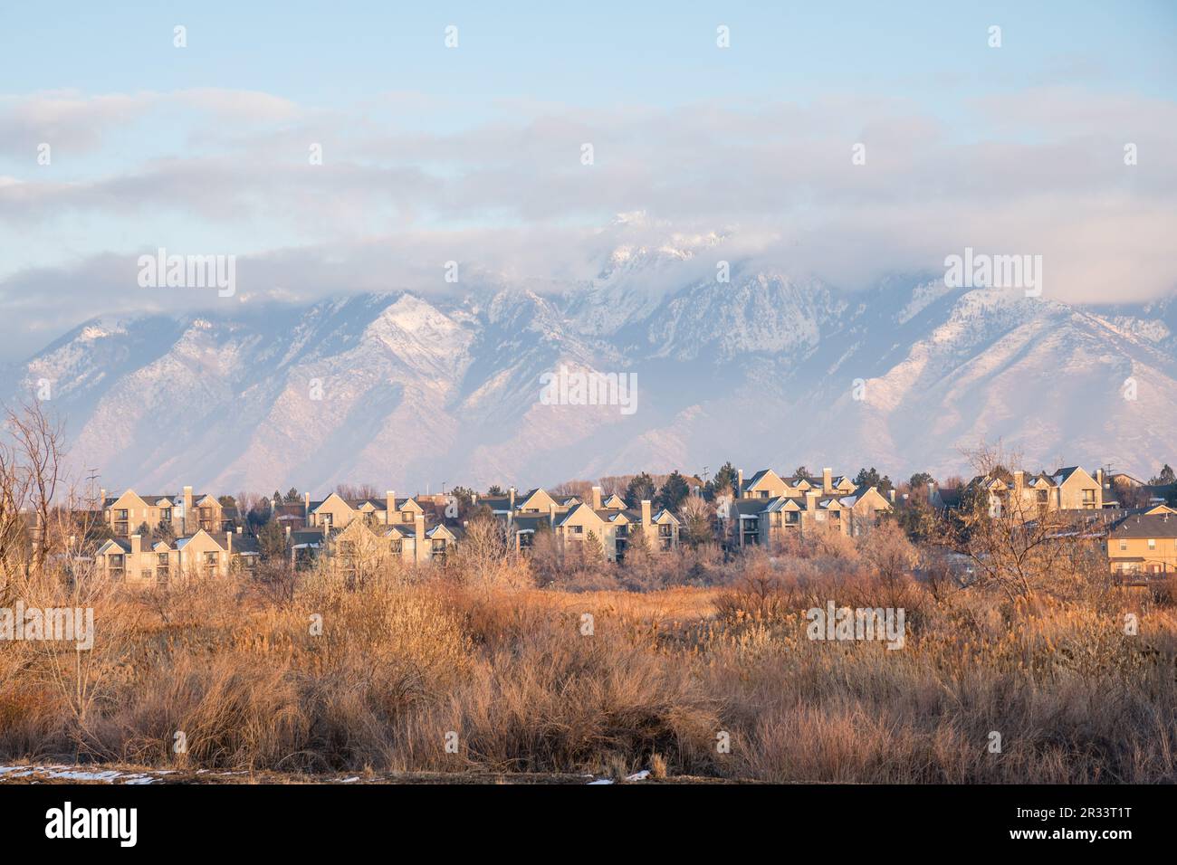 Neighborhood of new homes with snow covered mountains in background ...