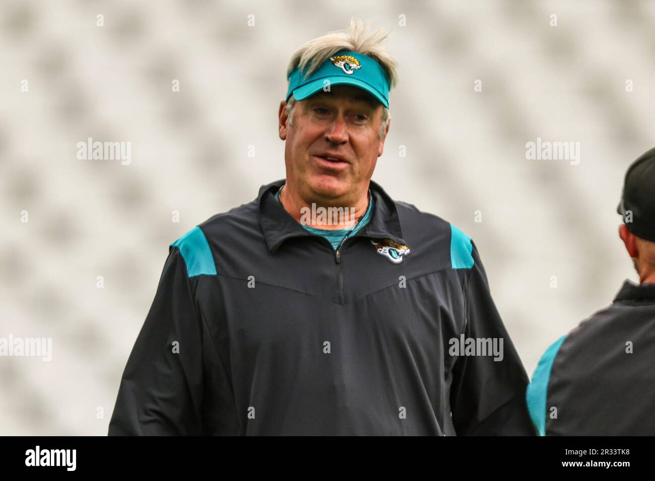 Jacksonville Jaguars head coach Doug Pederson talks with a staff member ...