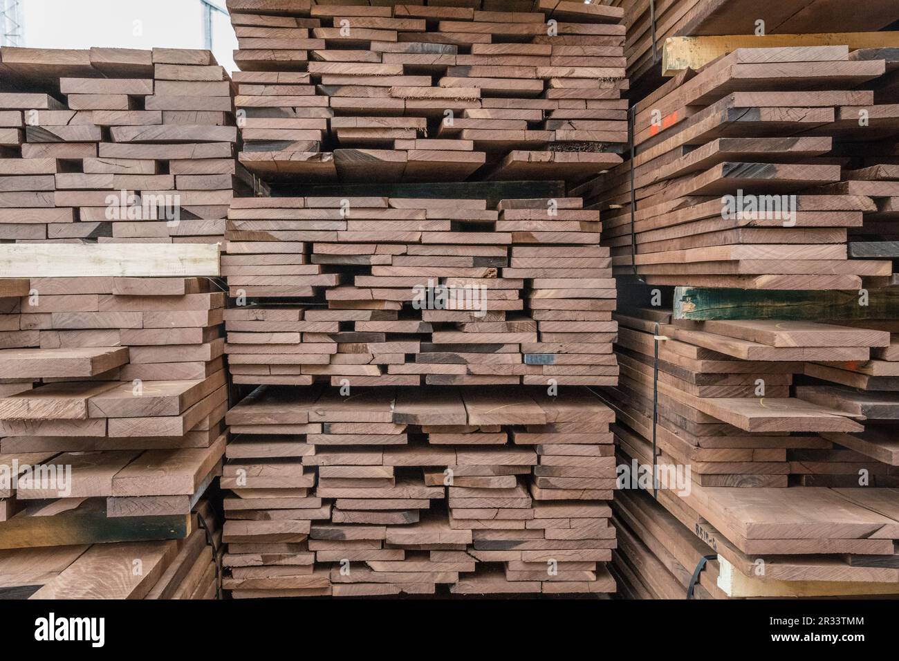 Stacks of lumber being stored in a warehouse Stock Photo - Alamy