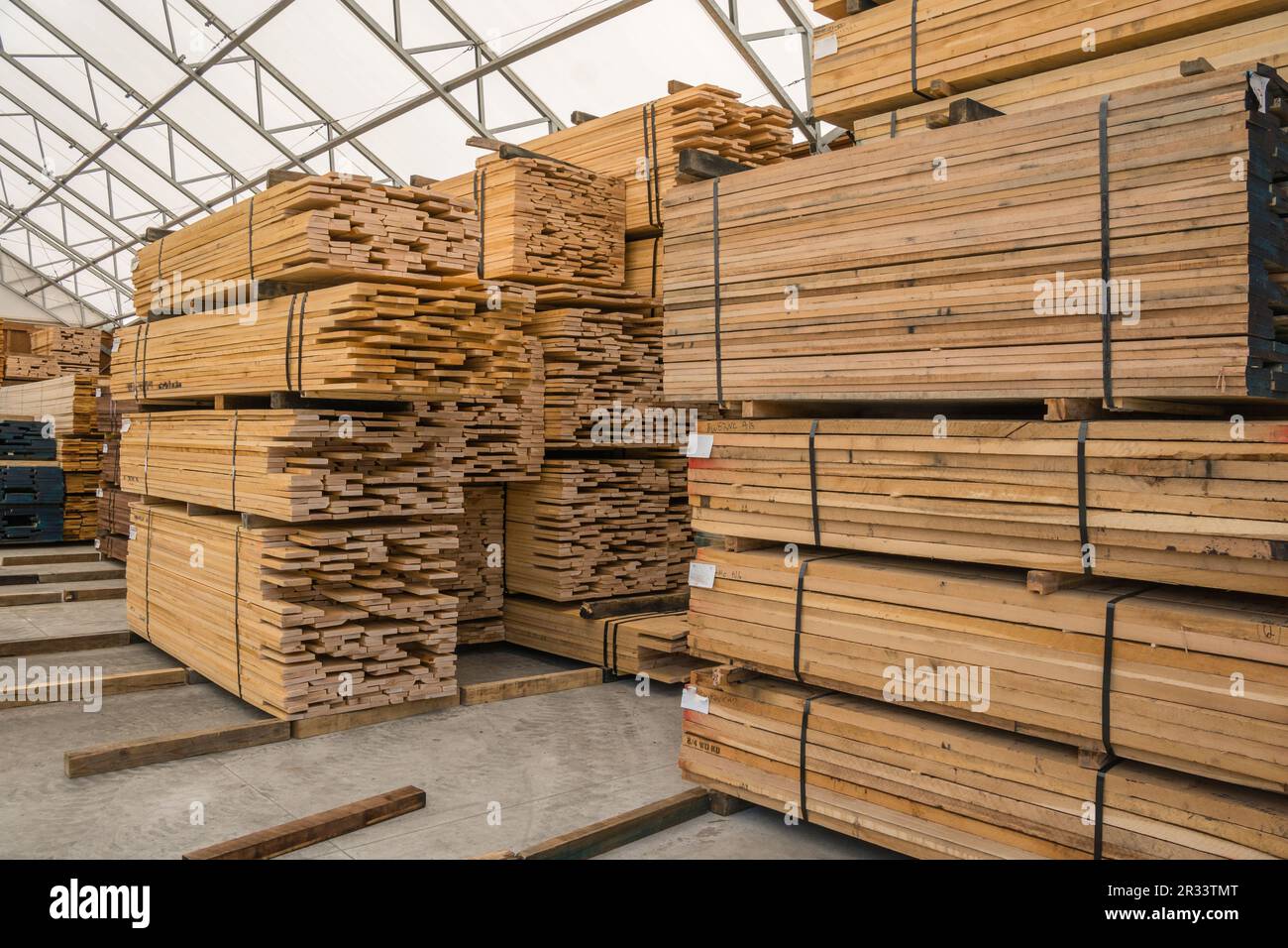 Stacks of lumber being stored in a warehouse Stock Photo - Alamy
