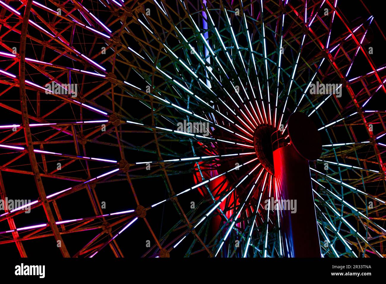 Colorful light fluorescent on structure of ferris wheel with dark night ...