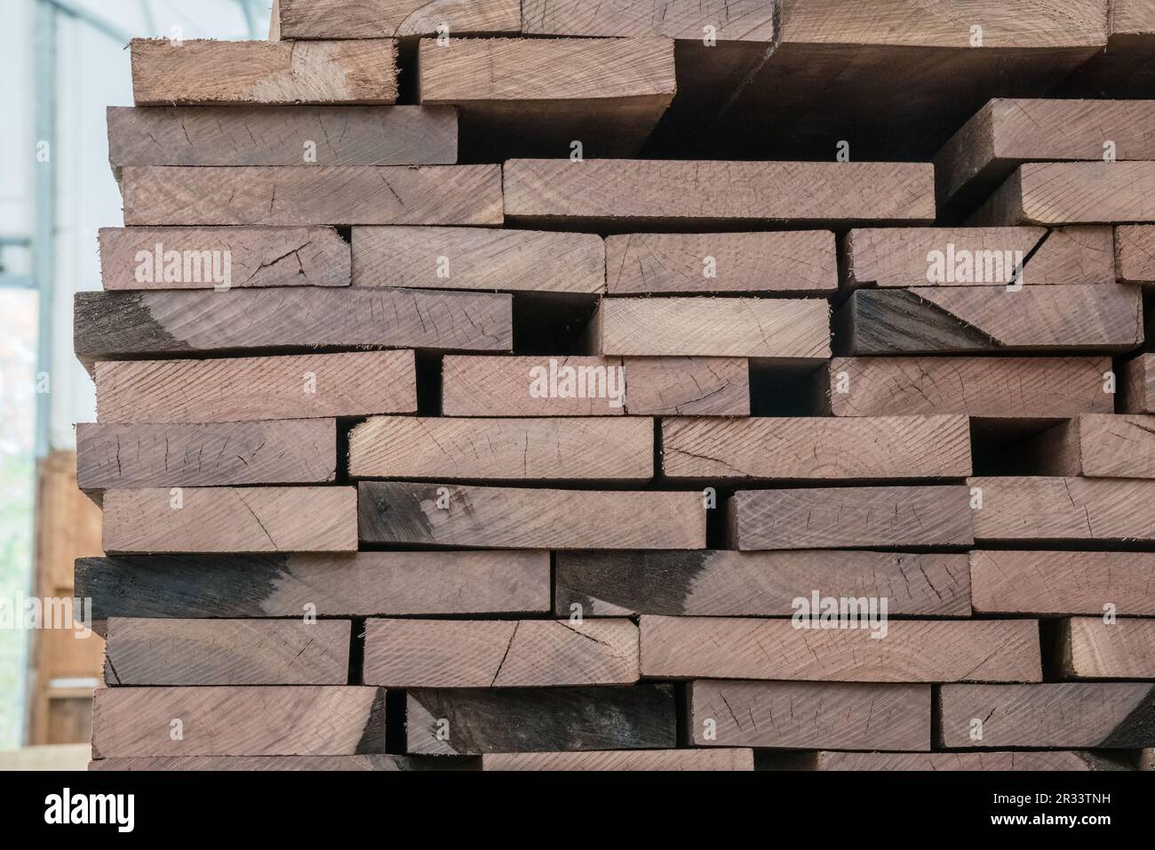 Stacks of lumber being stored in a warehouse Stock Photo - Alamy